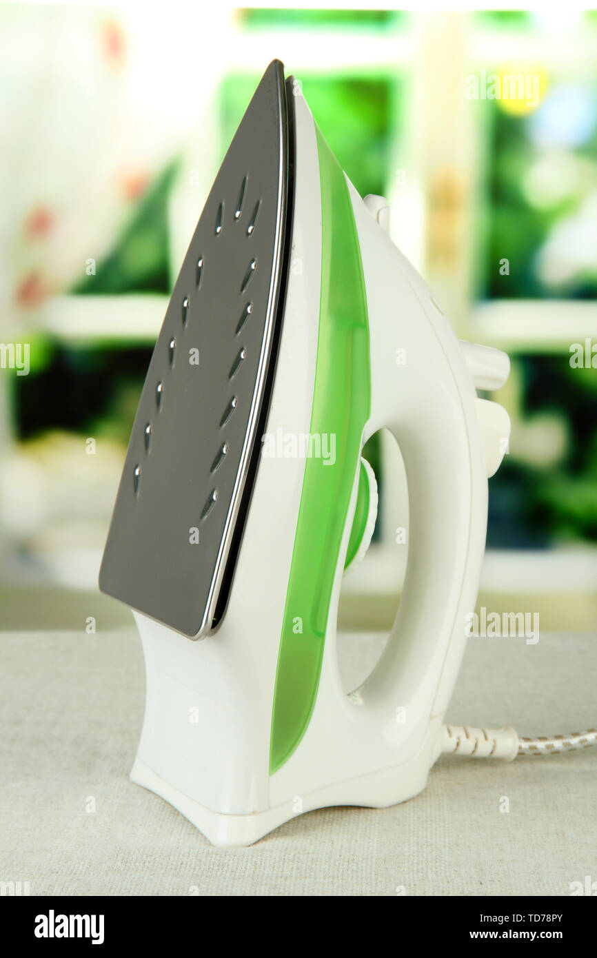 Steam iron on bright background Stock Photo - Alamy