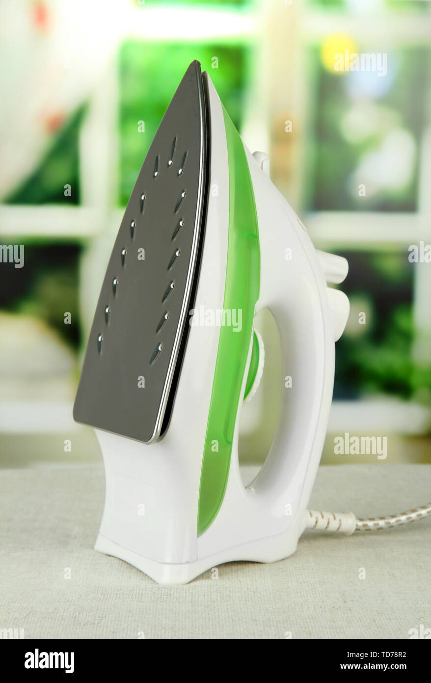 Steam iron on bright background Stock Photo - Alamy