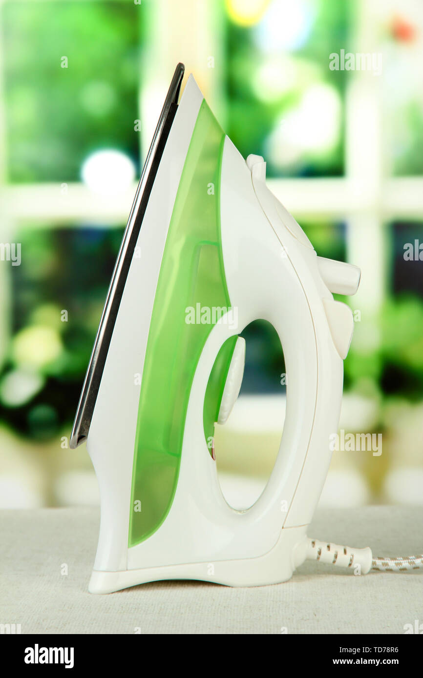 Steam iron on bright background Stock Photo - Alamy