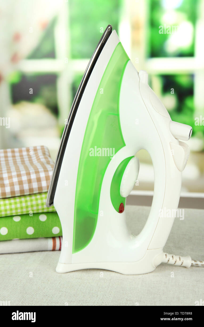 Steam iron on bright background Stock Photo - Alamy