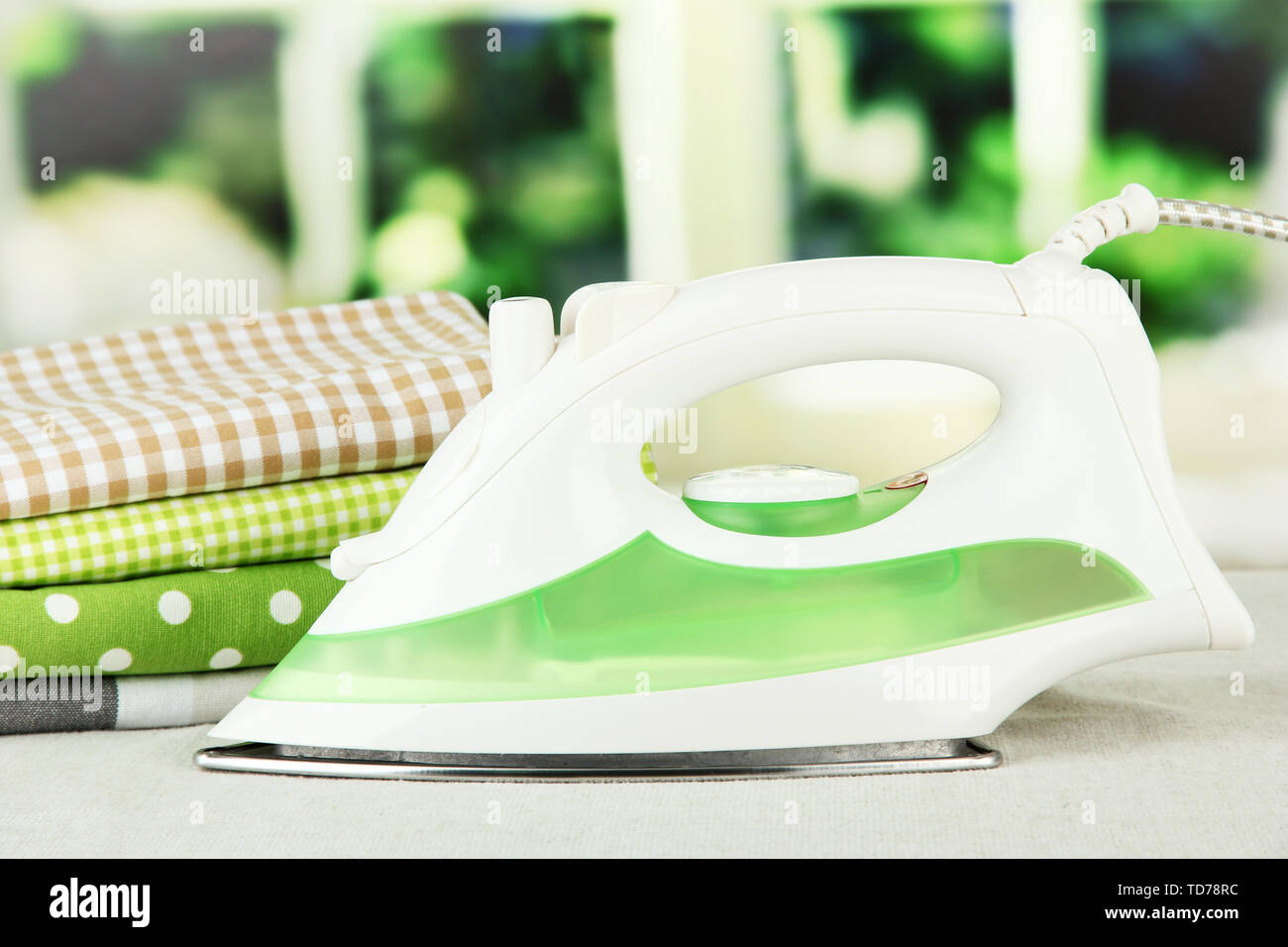 Steam iron on bright background Stock Photo - Alamy