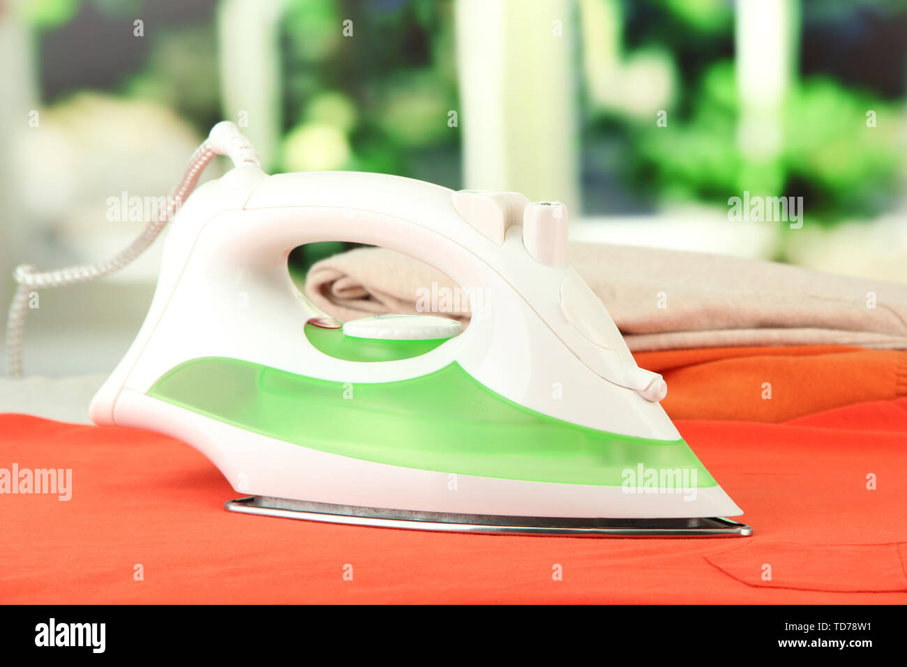 Steam iron on bright background Stock Photo - Alamy