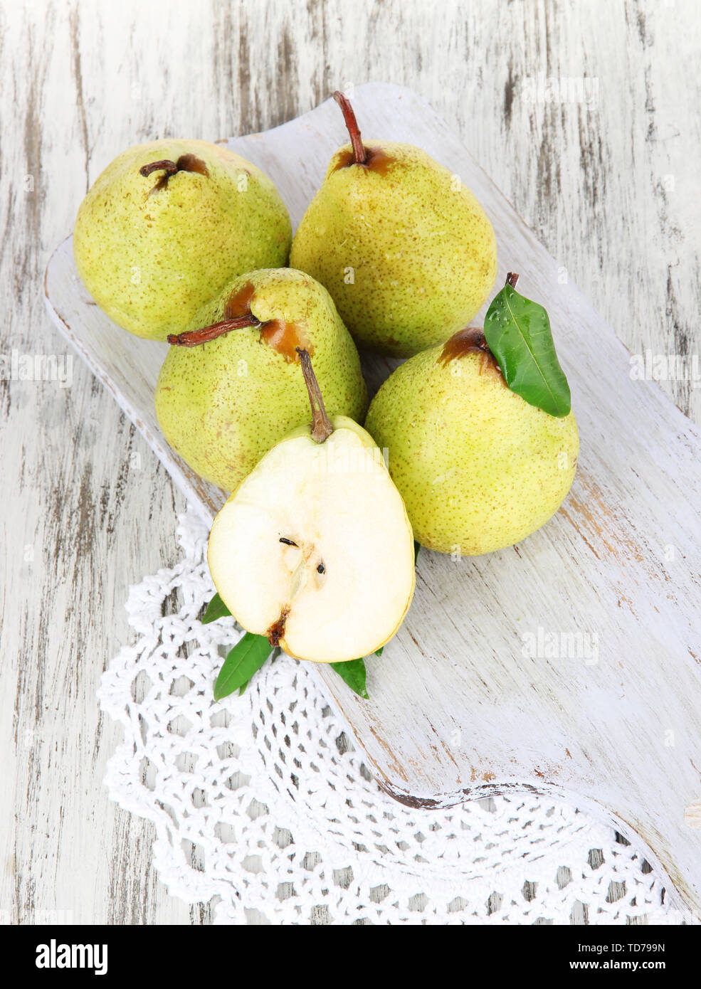 Pears on board on napkin on wooden background Stock Photo - Alamy