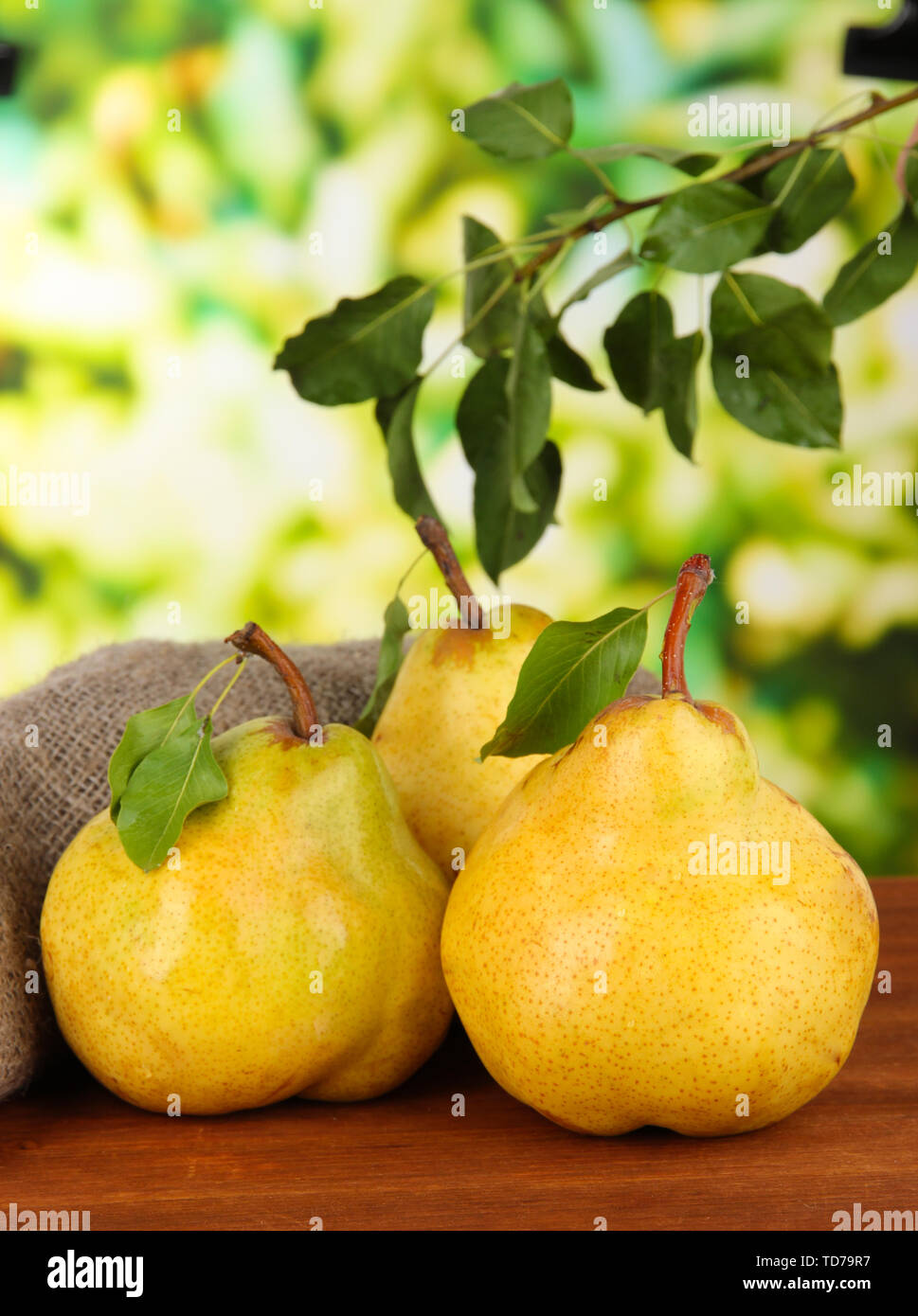 Juicy pears on table on bright background Stock Photo - Alamy
