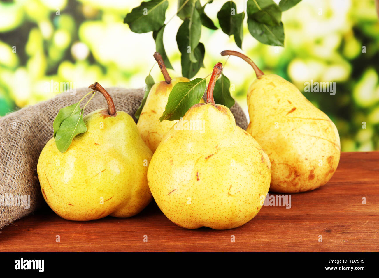 Juicy pears on table on bright background Stock Photo - Alamy