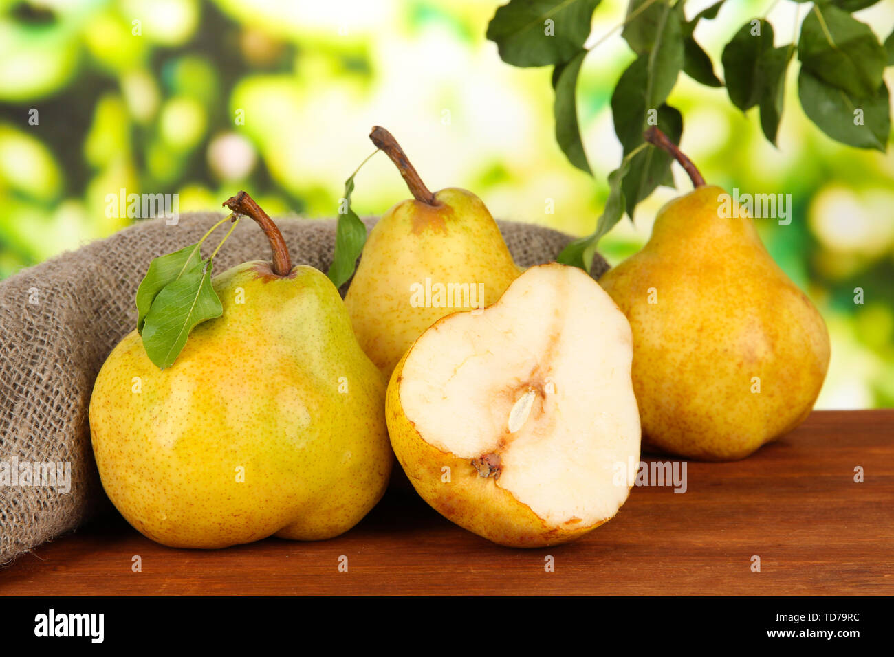 Juicy pears on table on bright background Stock Photo - Alamy