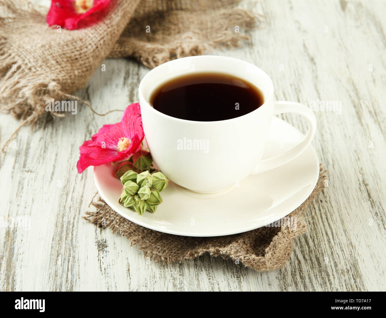Cup of coffee and pink mallow flowers on wooden background Stock Photo ...