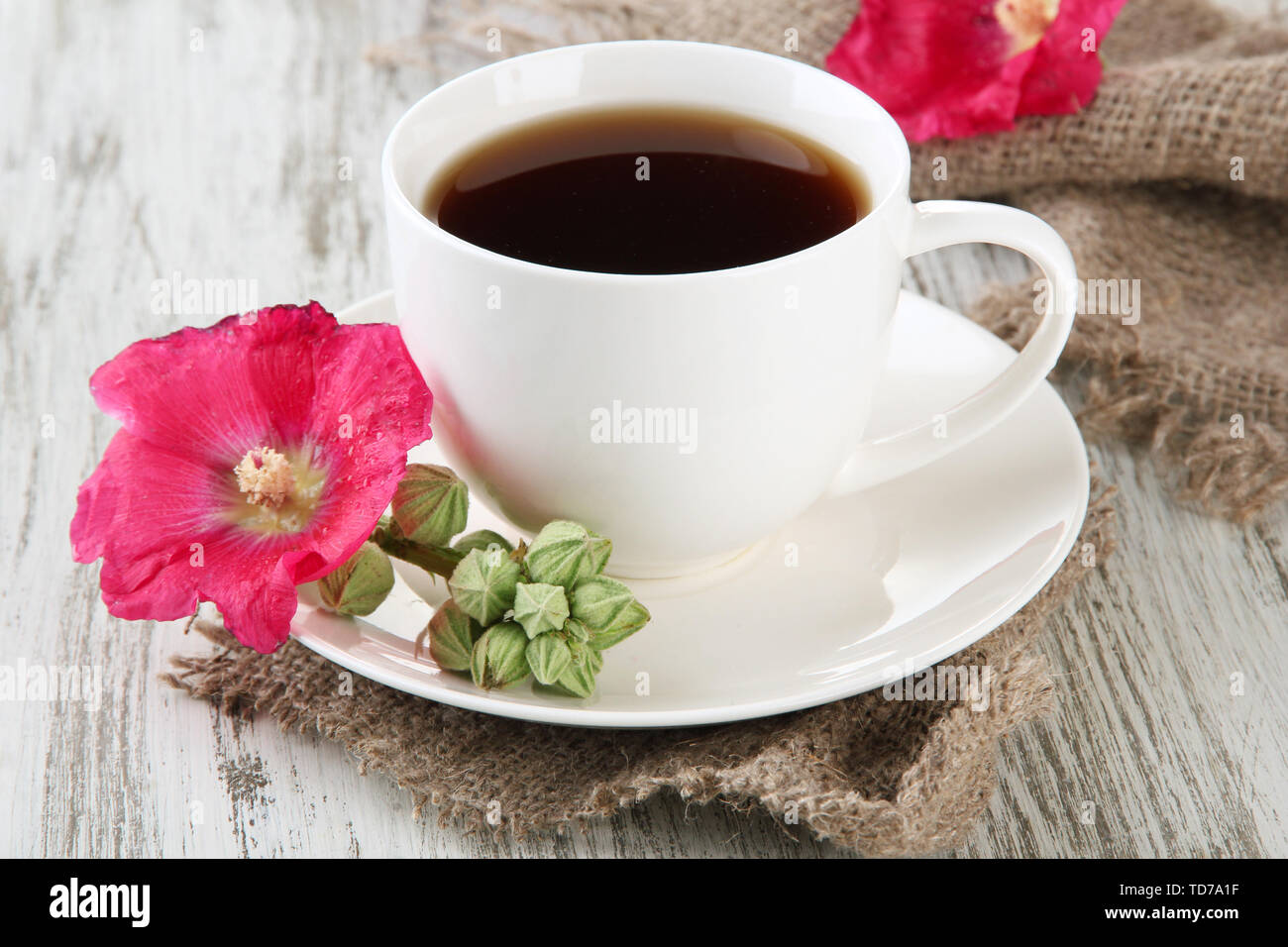 Cup of coffee and pink mallow flowers on wooden background Stock Photo ...