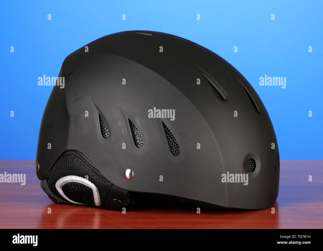 Winter sport helmet on blue background Stock Photo - Alamy