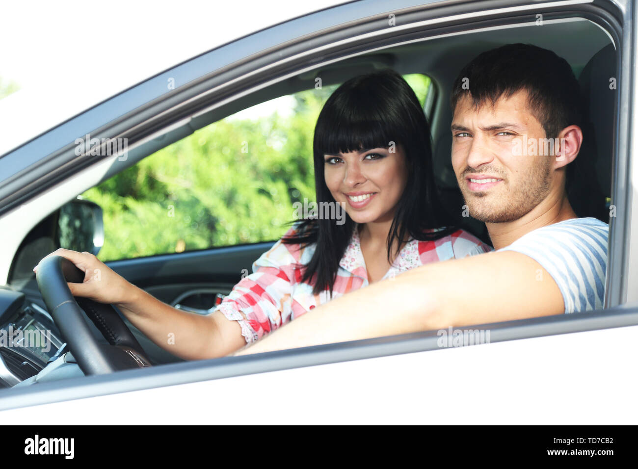 Beautiful happy young couple driving car Stock Photo - Alamy