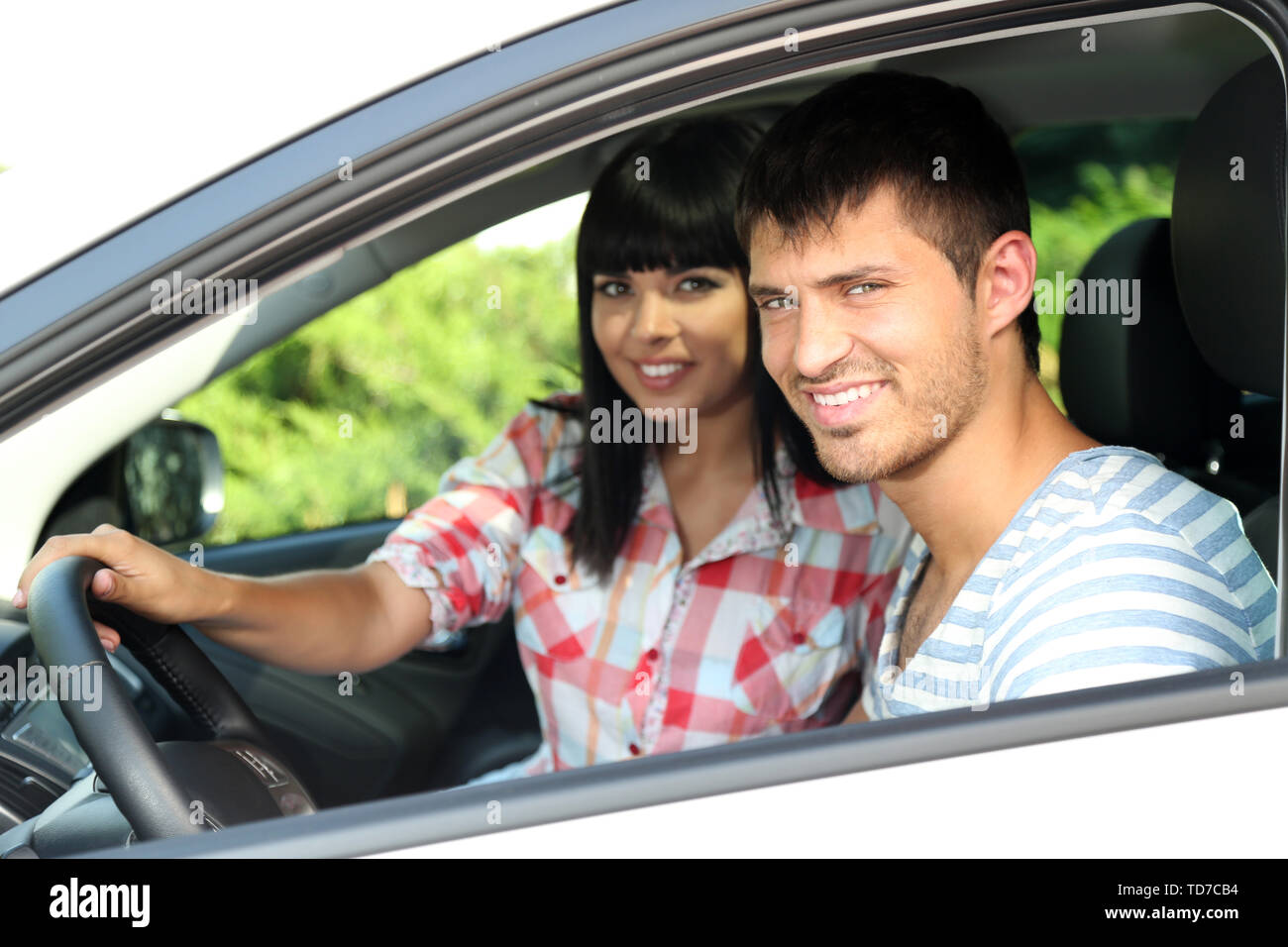 Beautiful happy young couple driving car Stock Photo - Alamy