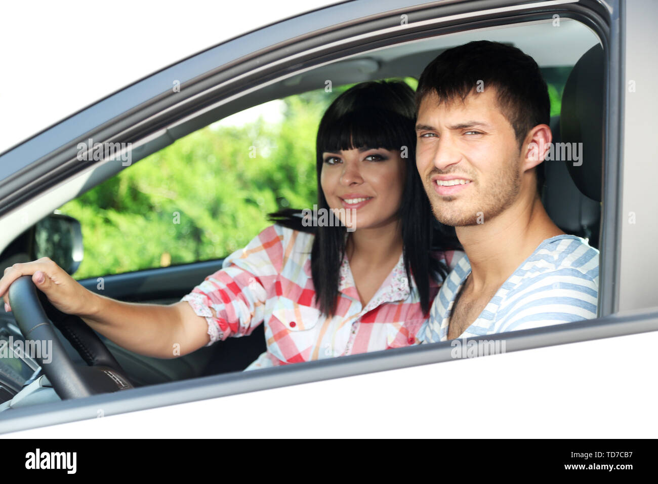 Beautiful happy young couple driving car Stock Photo - Alamy