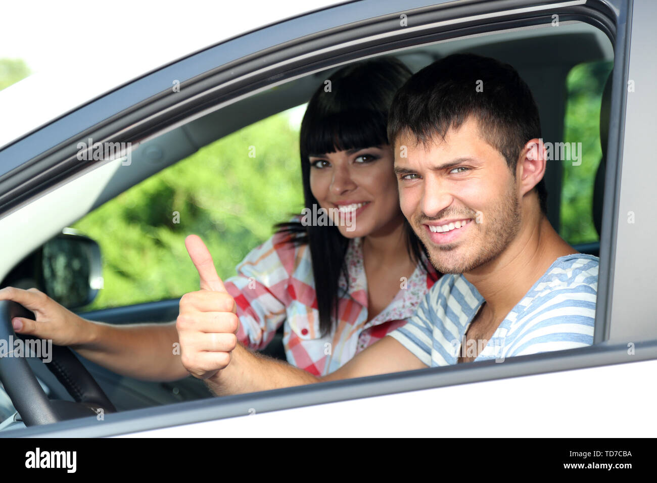 Beautiful happy young couple driving car Stock Photo - Alamy