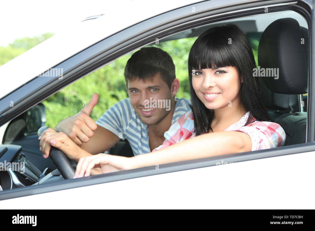 Beautiful happy young couple driving car Stock Photo - Alamy