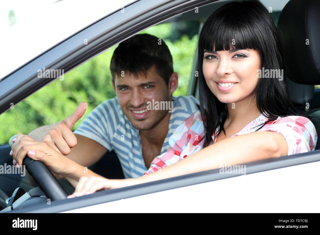 Beautiful happy young couple driving car Stock Photo - Alamy