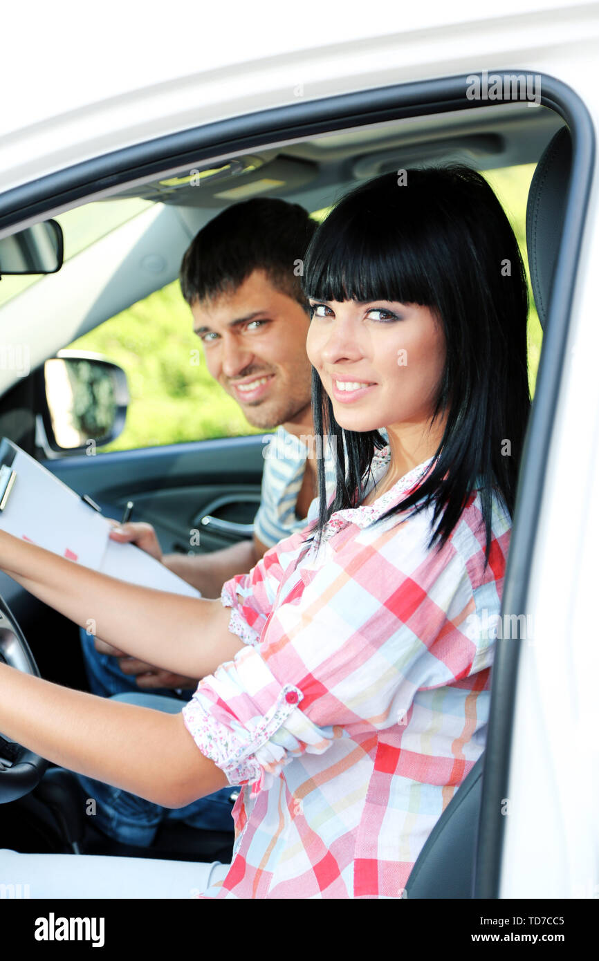 Beautiful young woman taking driving lesson Stock Photo - Alamy
