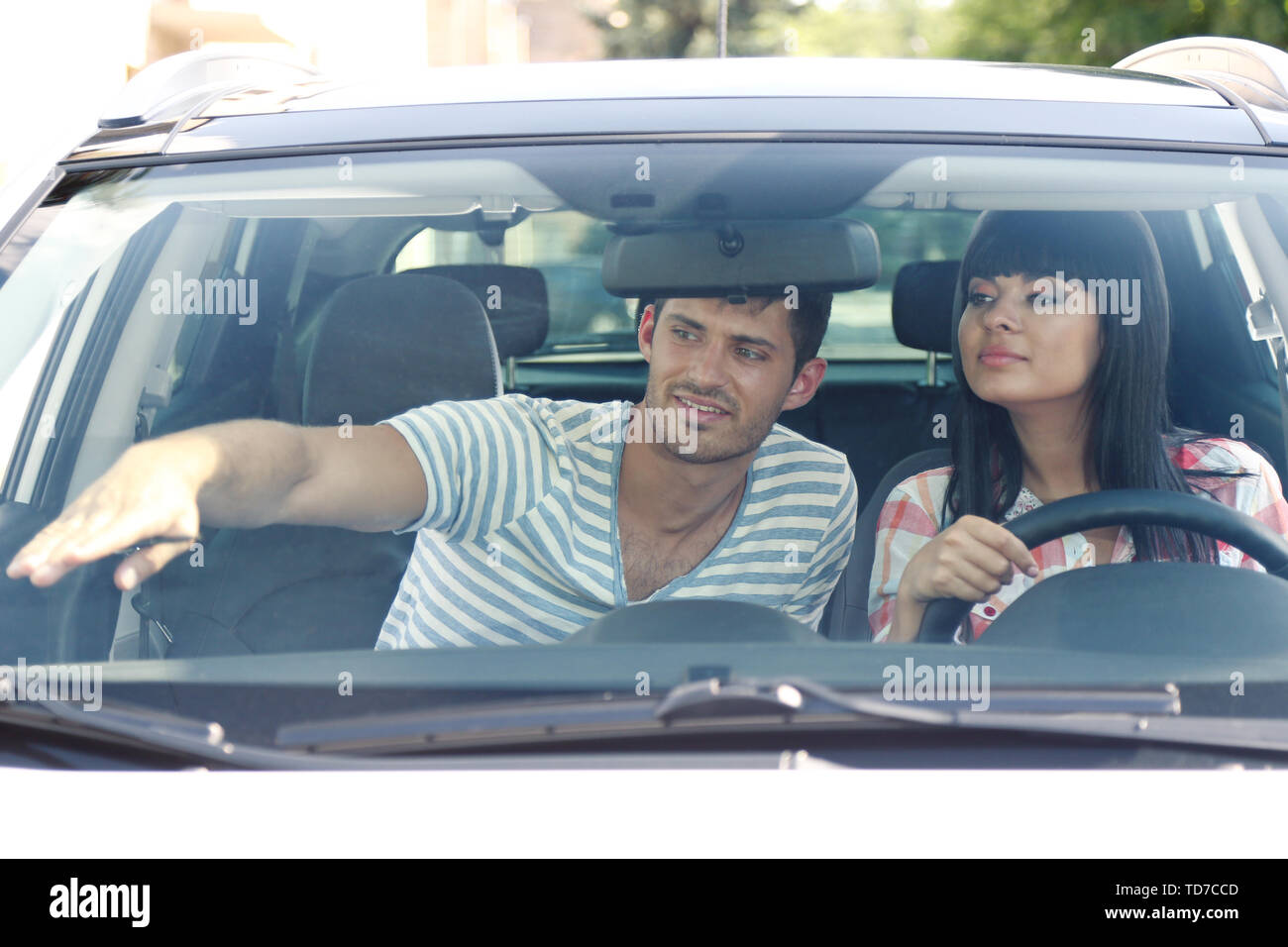 Beautiful young woman taking driving lesson Stock Photo - Alamy