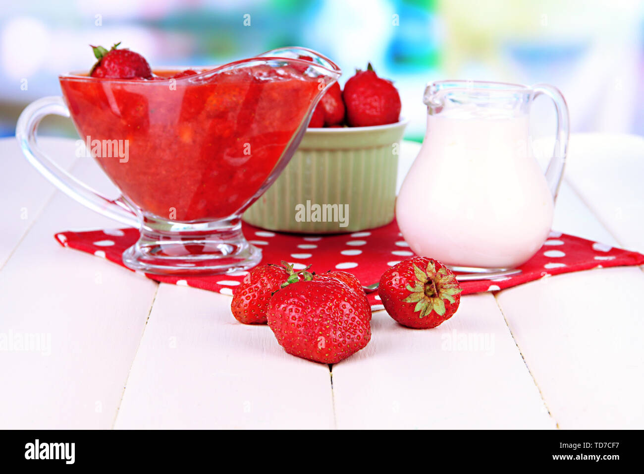 Homemade strawberry jam, on napkin, on color wooden table, on bright ...
