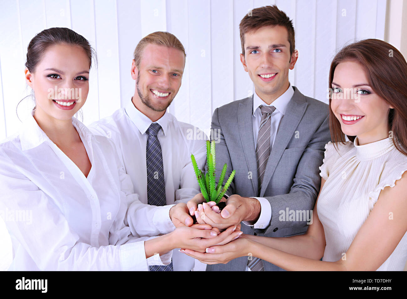 Young businessman holding sprout hi-res stock photography and images ...