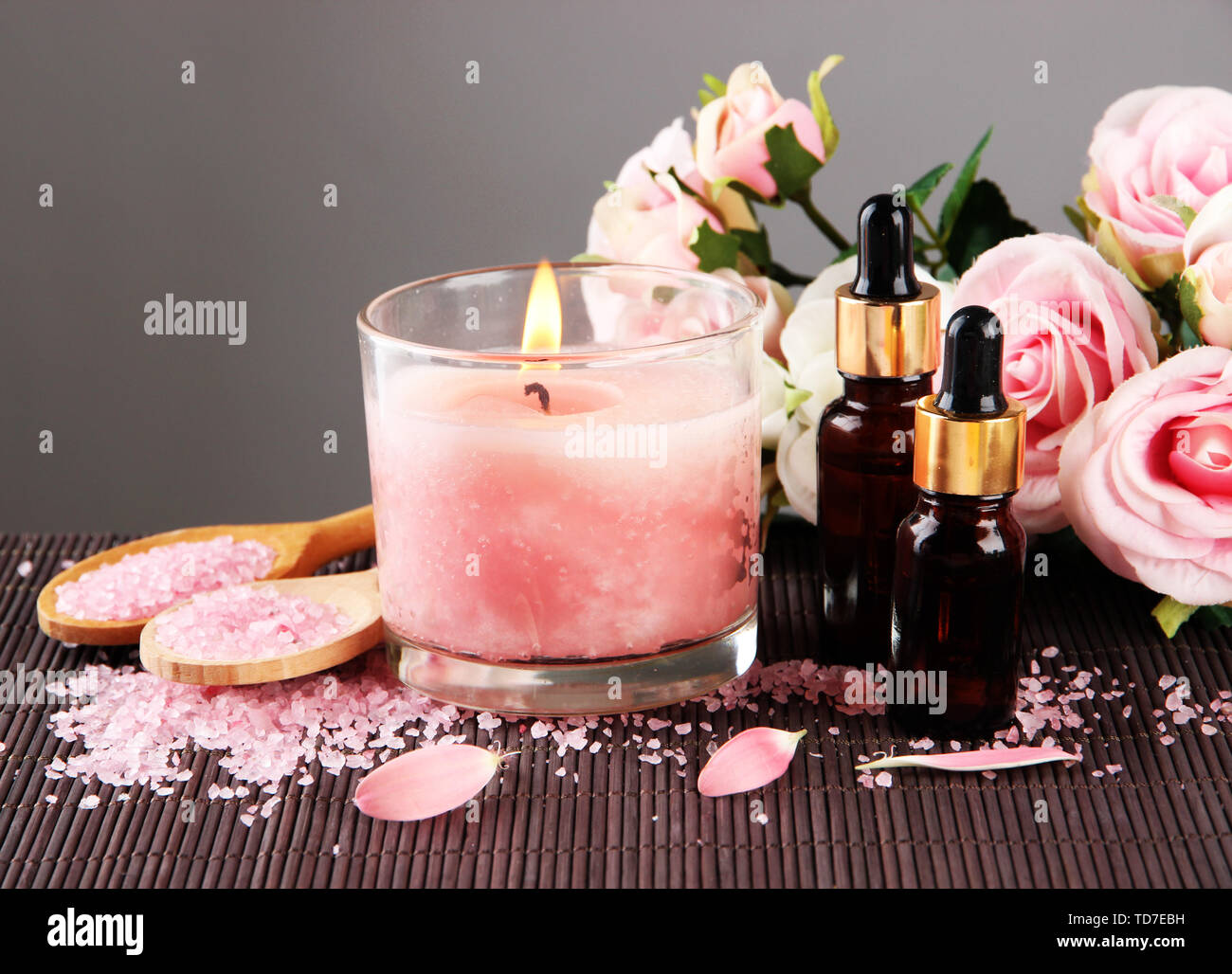 Beautiful pink candle with flowers and towel on bamboo mat Stock Photo ...