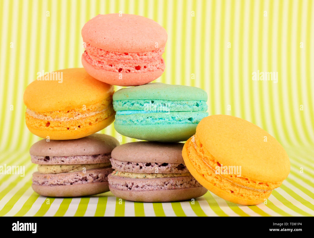 Gentle macaroons on green background Stock Photo - Alamy
