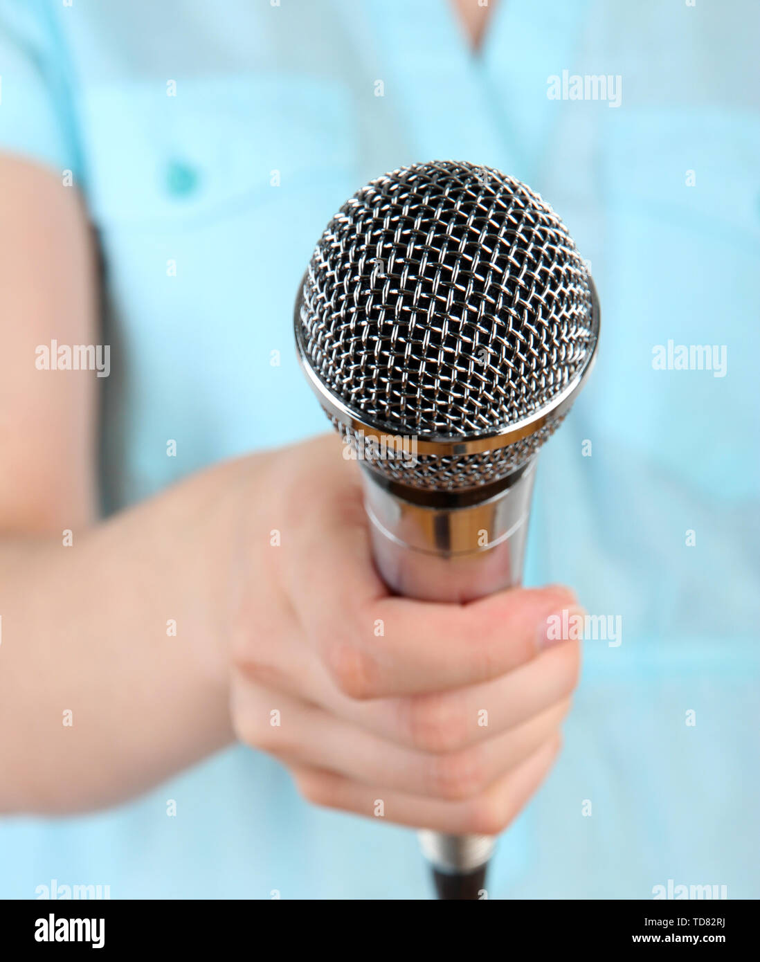 Female with microphone close-up background Stock Photo - Alamy