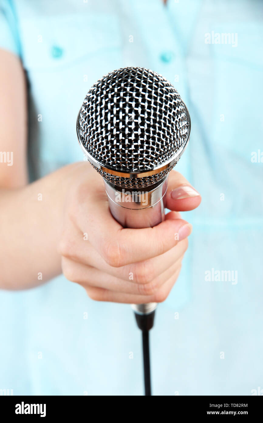 Female with microphone close-up background Stock Photo - Alamy