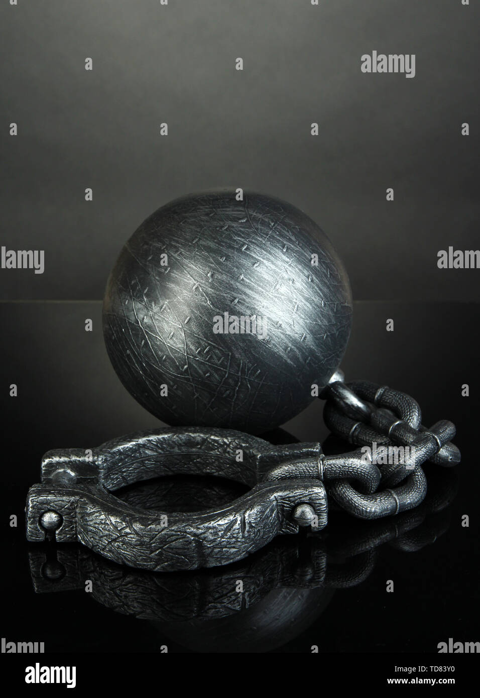 Ball and chain on grey background Stock Photo - Alamy