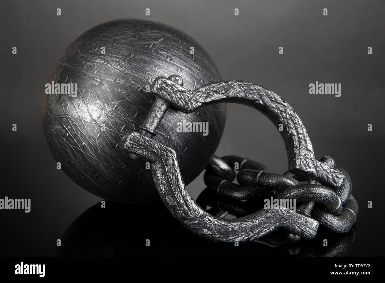 Ball and chain on grey background Stock Photo - Alamy