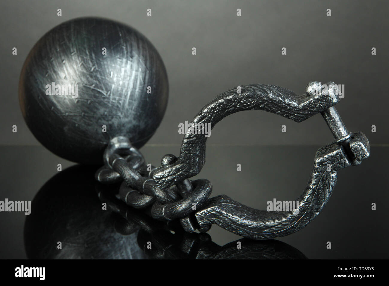 Ball and chain on grey background Stock Photo - Alamy