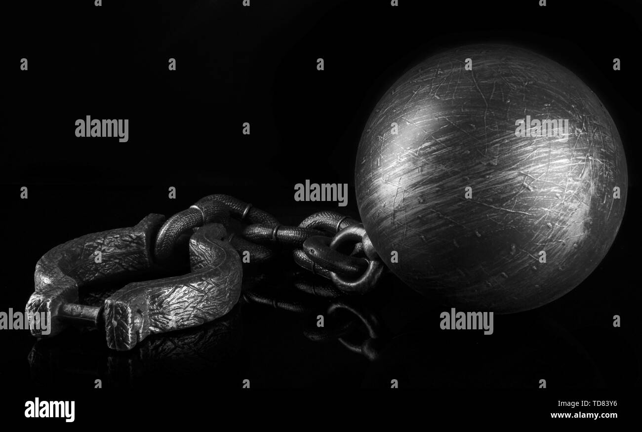 Ball and chain on black background Stock Photo - Alamy