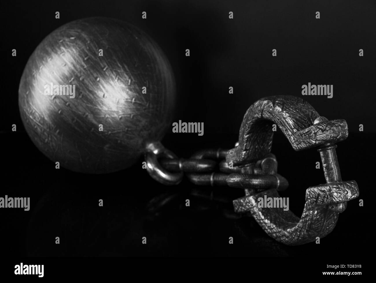 Ball and chain on black background Stock Photo - Alamy