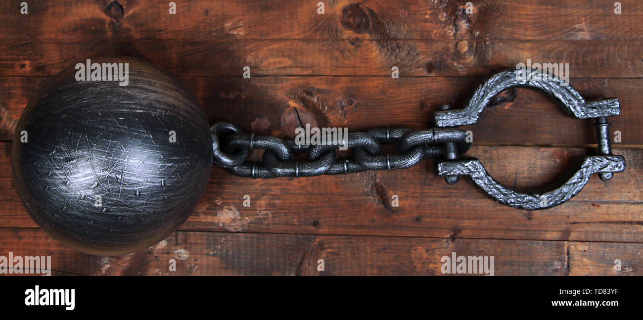 Ball and chain on wooden background Stock Photo - Alamy