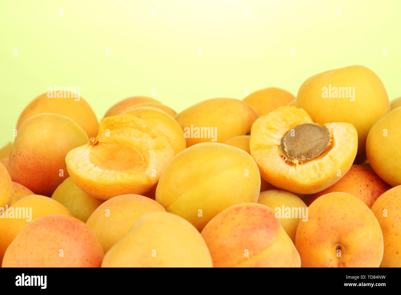 Fresh natural apricot on green background Stock Photo - Alamy