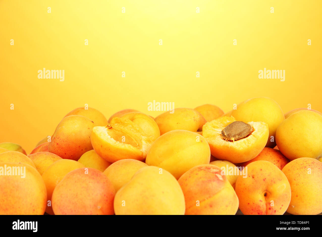 Fresh natural apricot on orange background Stock Photo - Alamy