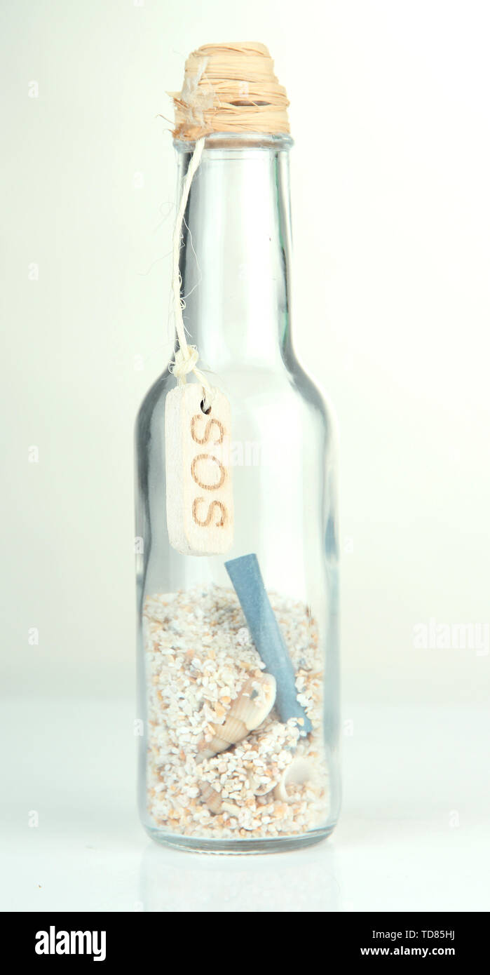 Glass of bottle with note inside on isolated on white Stock Photo - Alamy