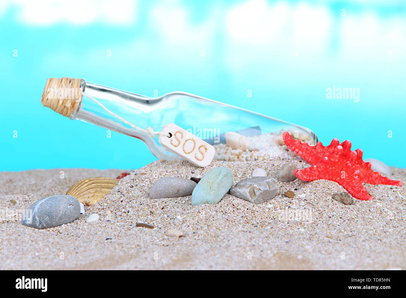 Glass of bottle with note inside on bright blue background Stock Photo ...