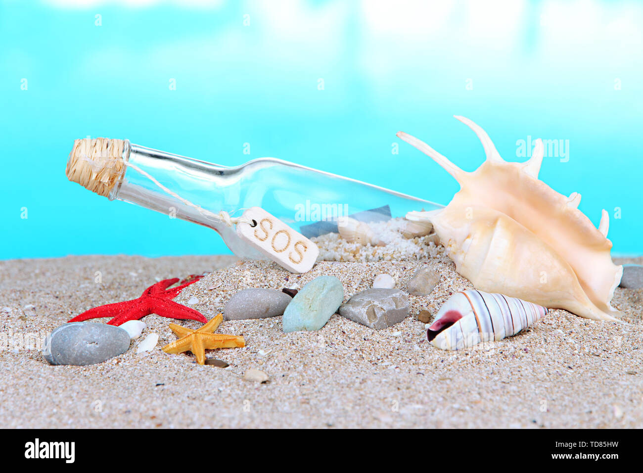 Glass of bottle with note inside on bright blue background Stock Photo ...