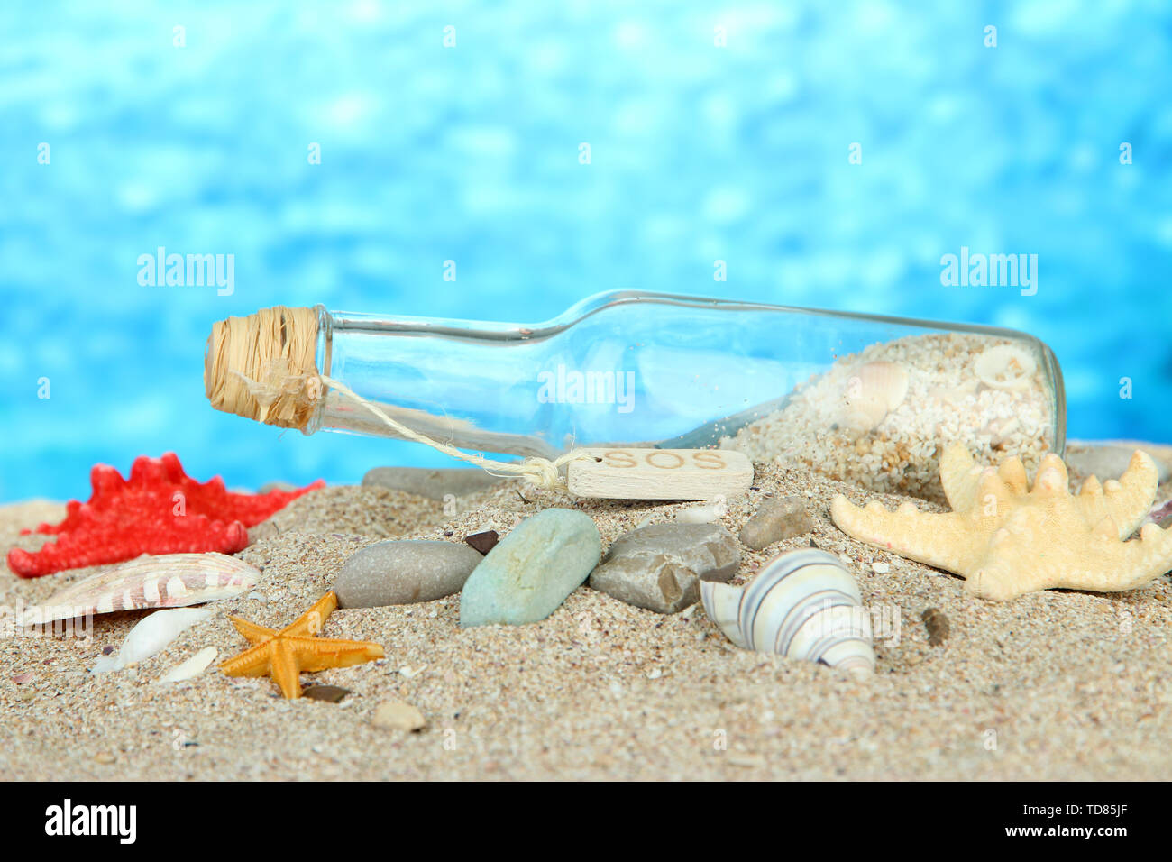 Glass of bottle with note inside on bright blue background Stock Photo ...