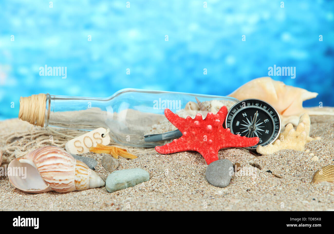 Glass of bottle with note inside on bright blue background Stock Photo ...