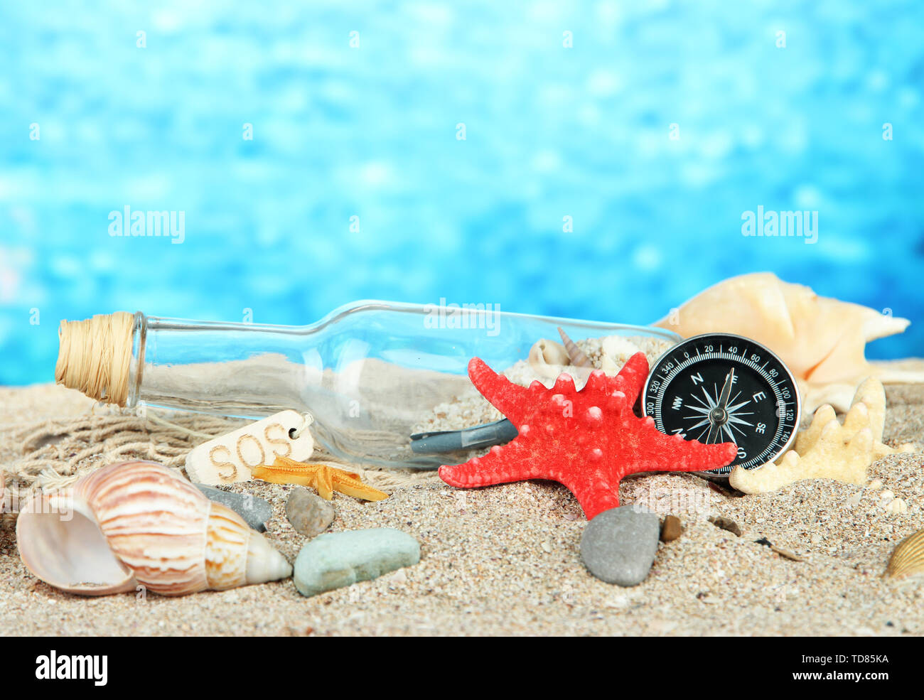 Glass of bottle with note inside on bright blue background Stock Photo ...