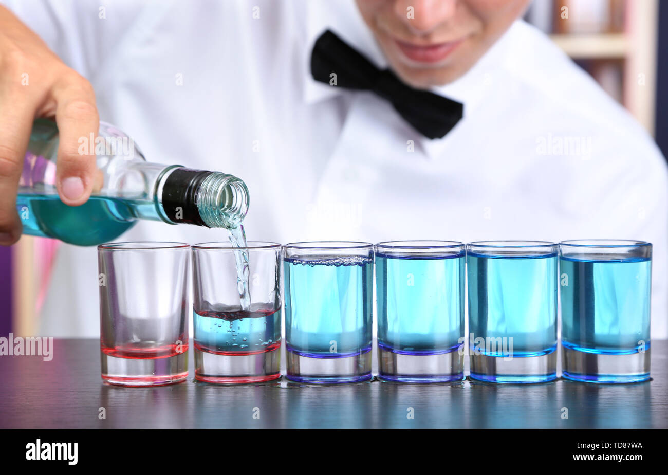 Bartender is pouring liquor into glass Stock Photo - Alamy