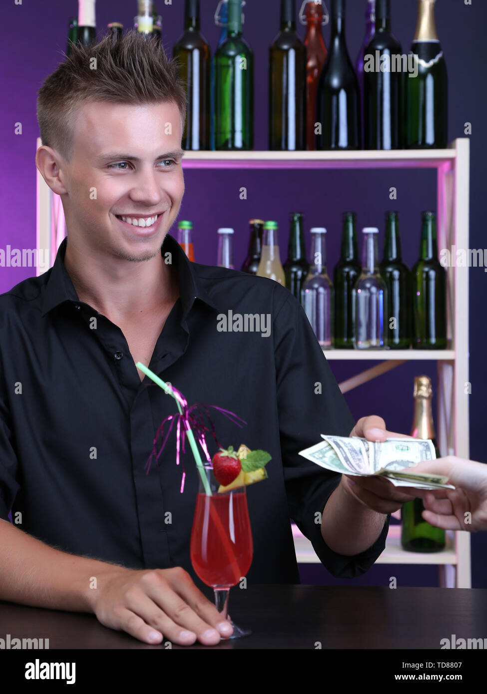 Portrait of handsome barman receiving tips from client Stock Photo - Alamy