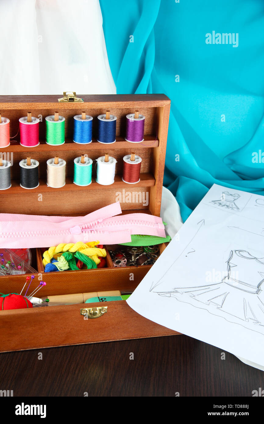 Sewing kit in wooden box,cloth and sketch on wooden table Stock Photo ...