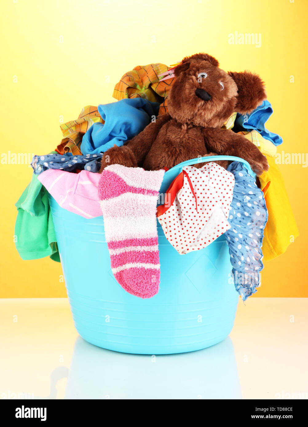 Blue laundry basket on orange background Stock Photo - Alamy