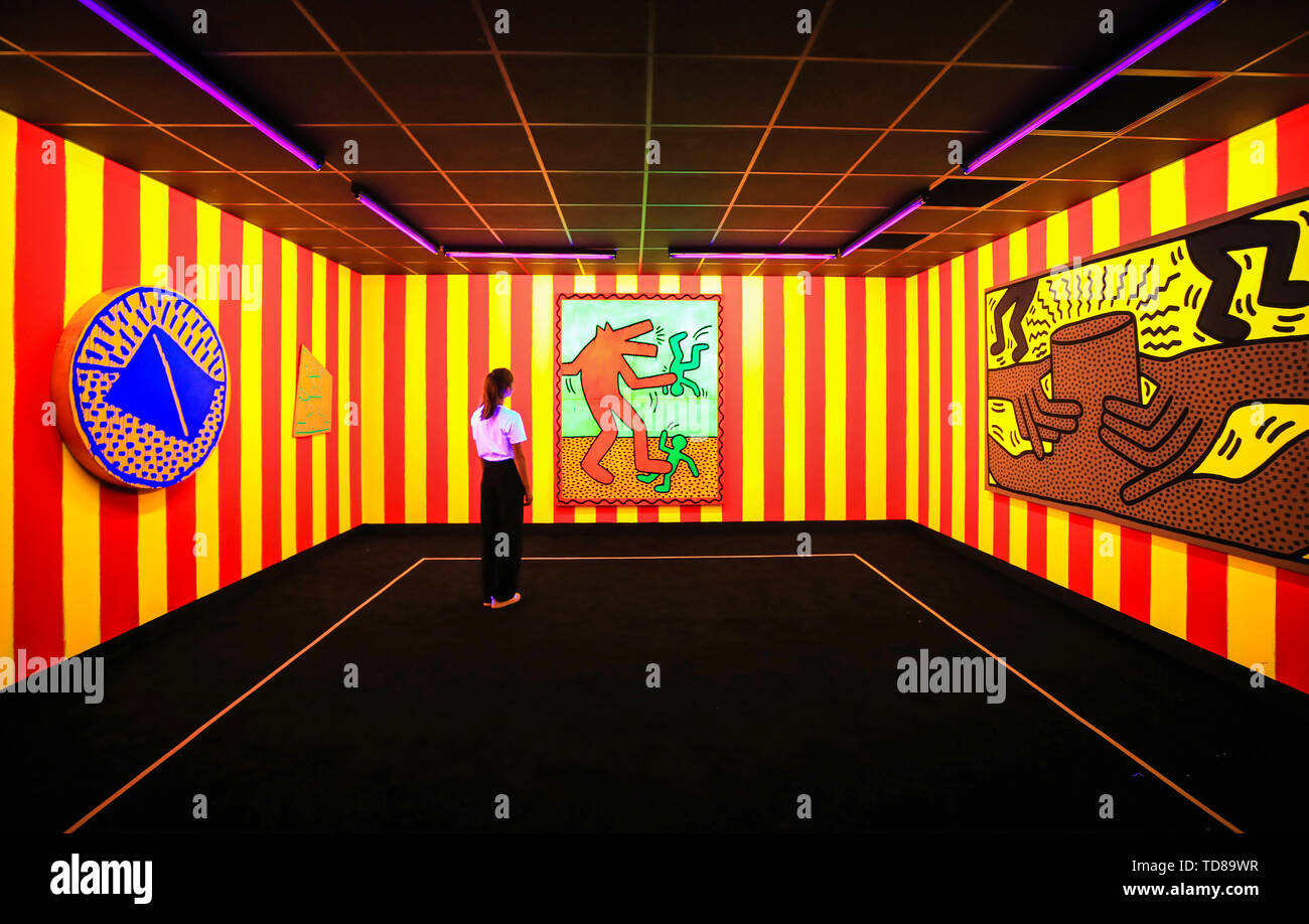 A visitor looks at an artwork during a preview of the Keith Haring ...