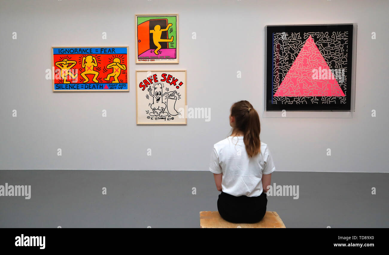 A visitor looks at artworks during a preview of the Keith Haring ...
