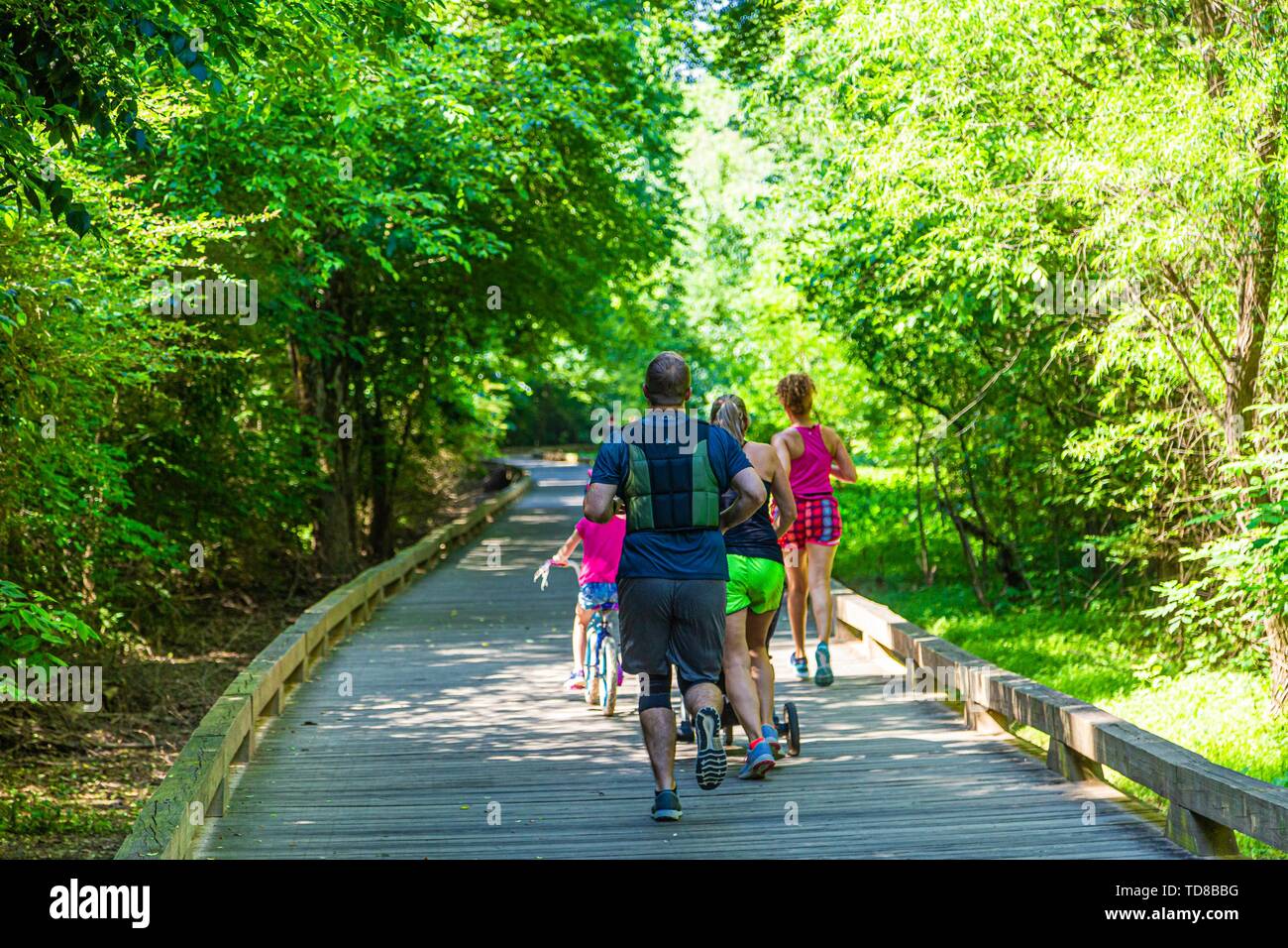 Family Running on Trail Stock Photo - Alamy