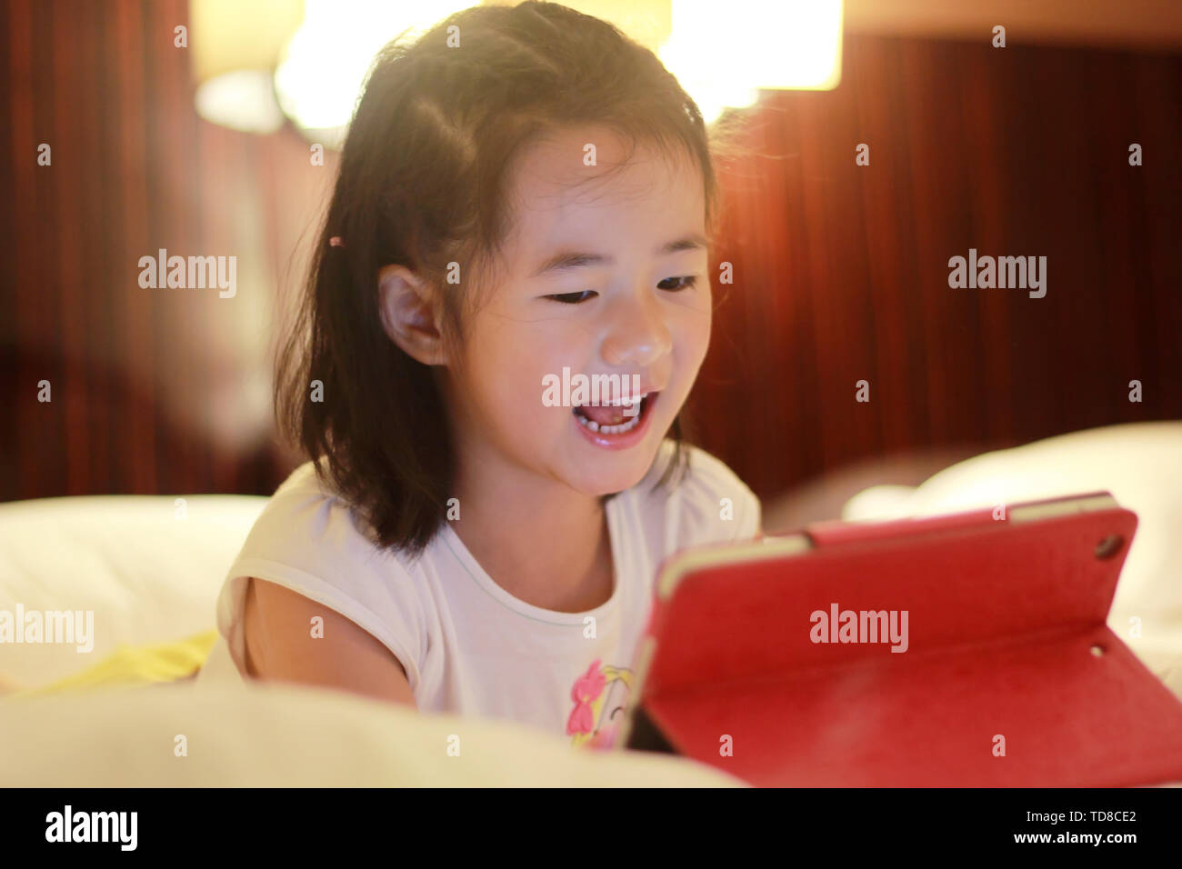 Little girl playing tablet Stock Photo - Alamy