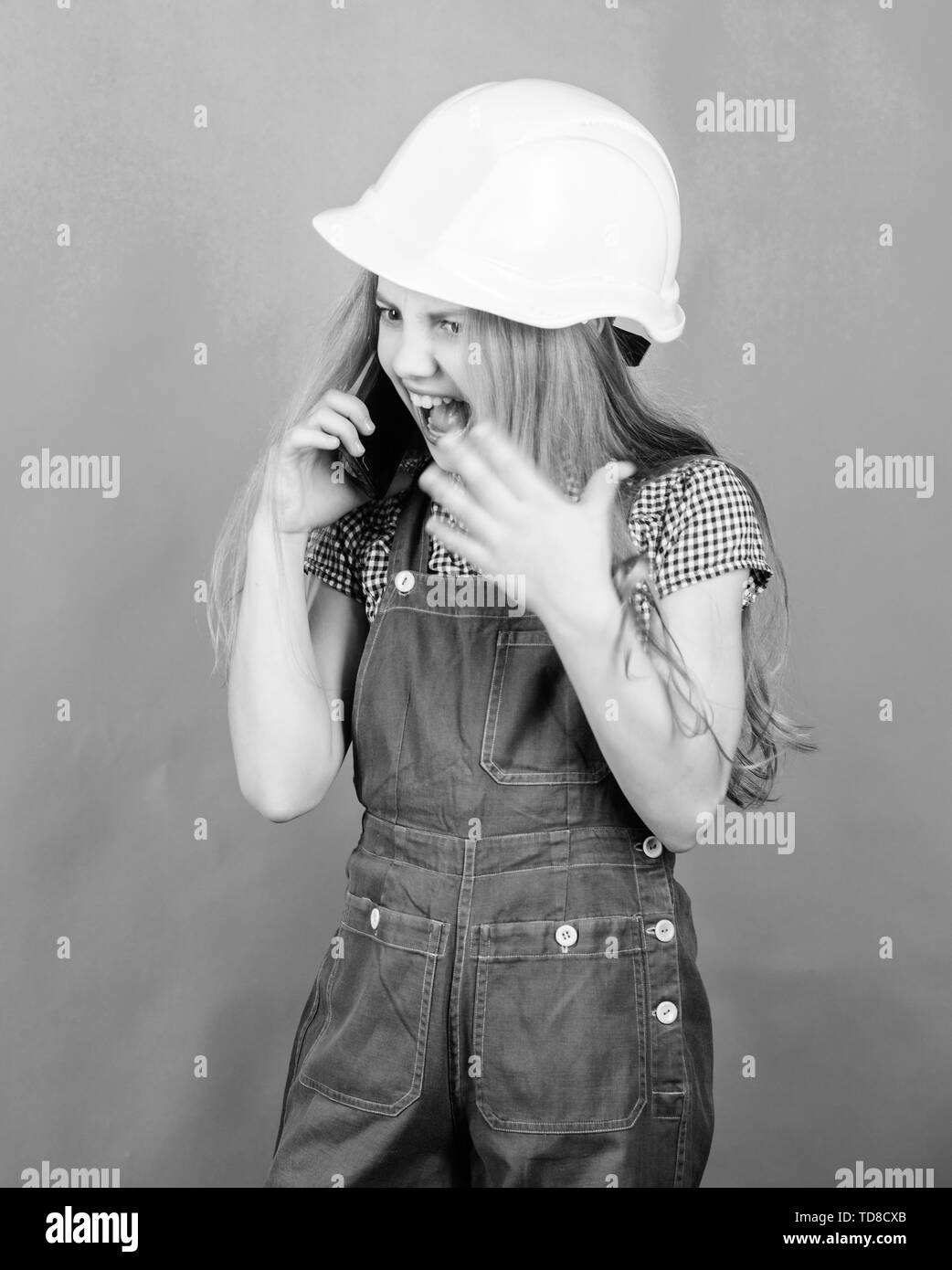 Builder engineer architect. Kid worker in hard hat angry. shouting on ...